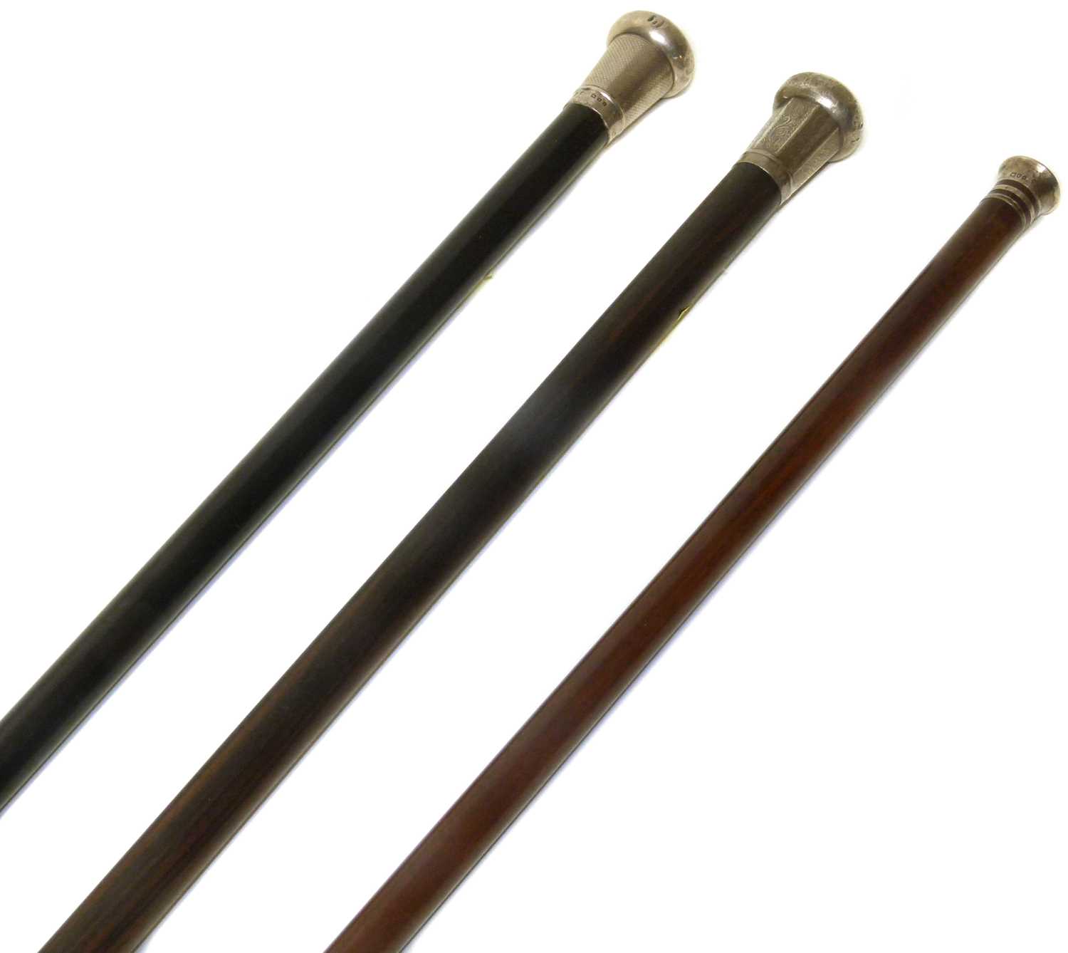 Lot 51 - Three silver topped walking canes.