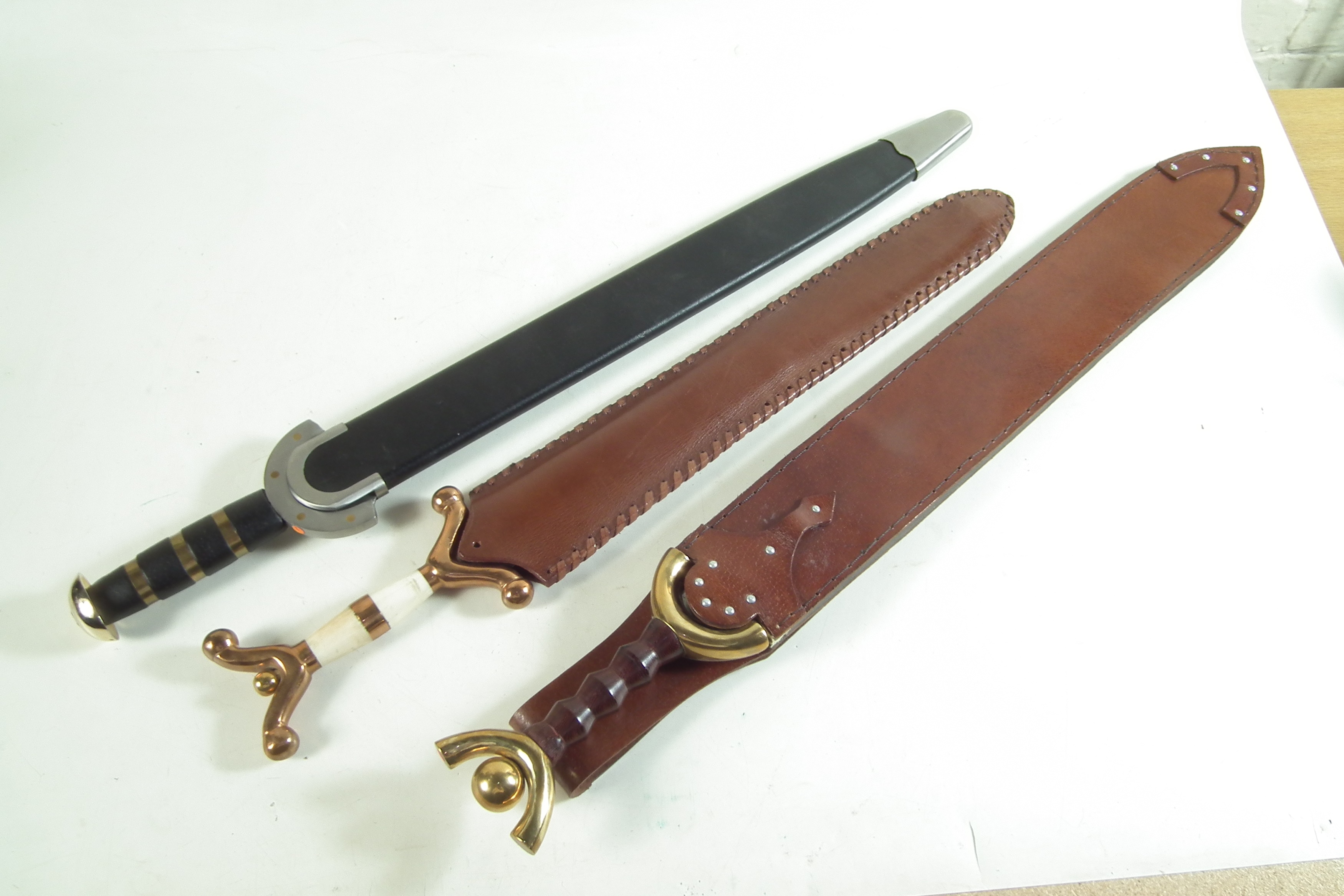 Lot 339 - Three modern replicas of Celtic swords and