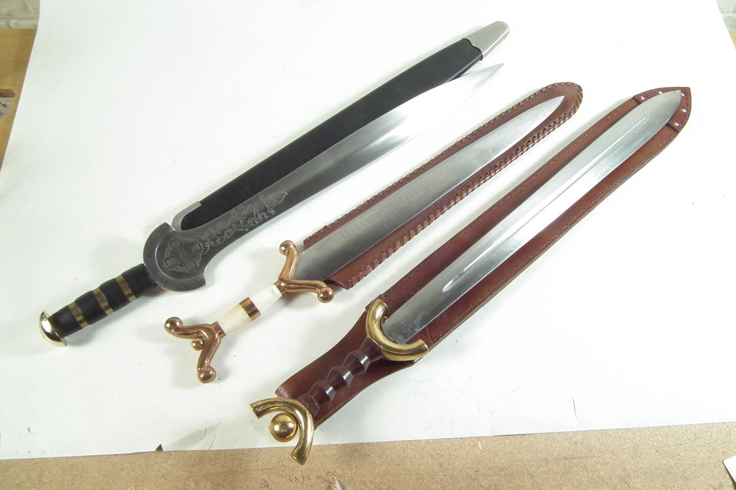 Lot 339 - Three modern replicas of Celtic swords and