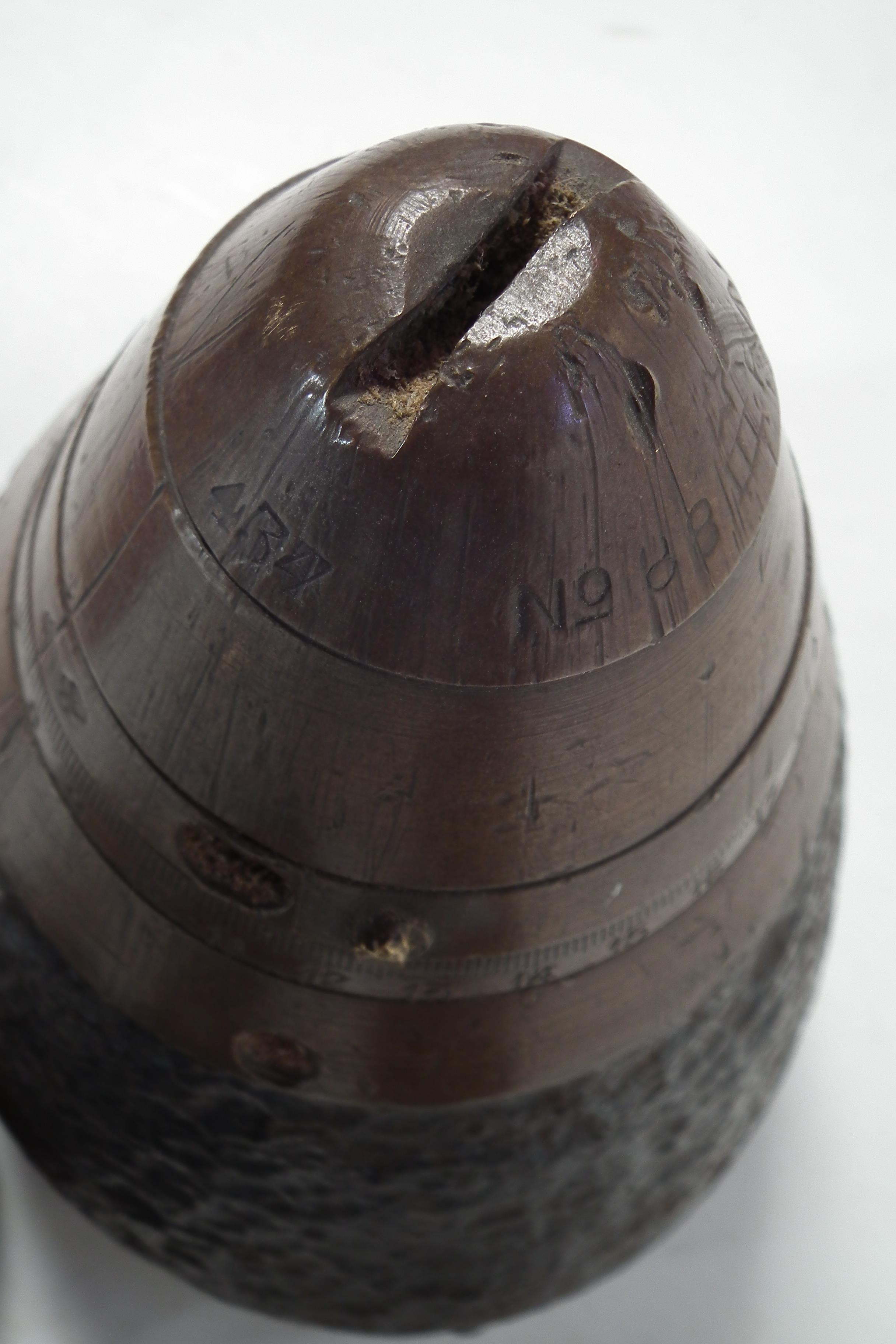 Lot 149 - Three WWI artillery fuses and a shell case