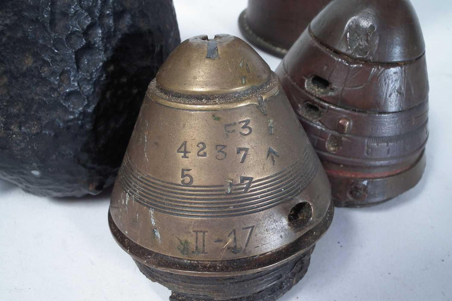 Lot 149 - Three WWI artillery fuses and a shell case
