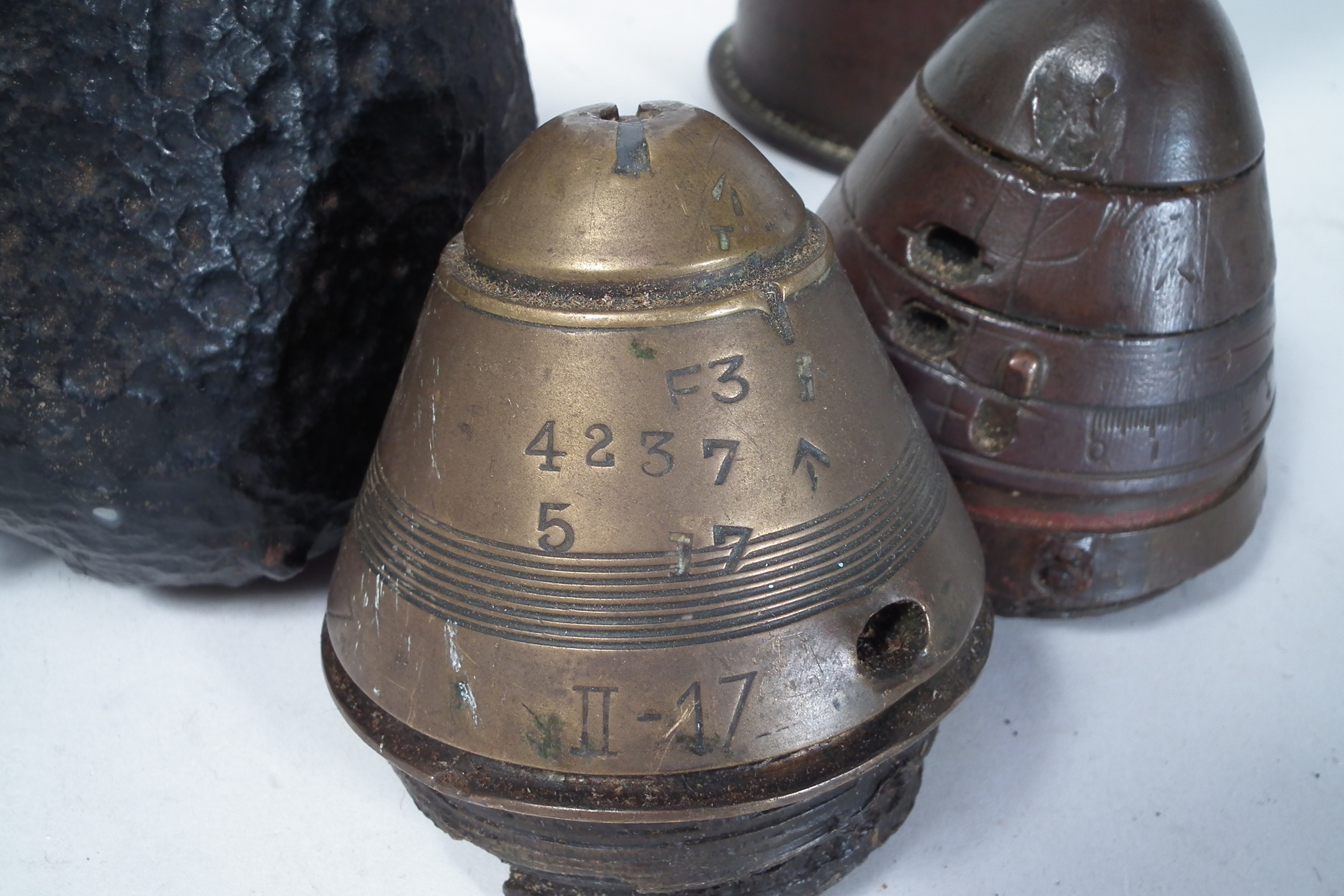 Lot 149 - Three WWI artillery fuses and a shell case