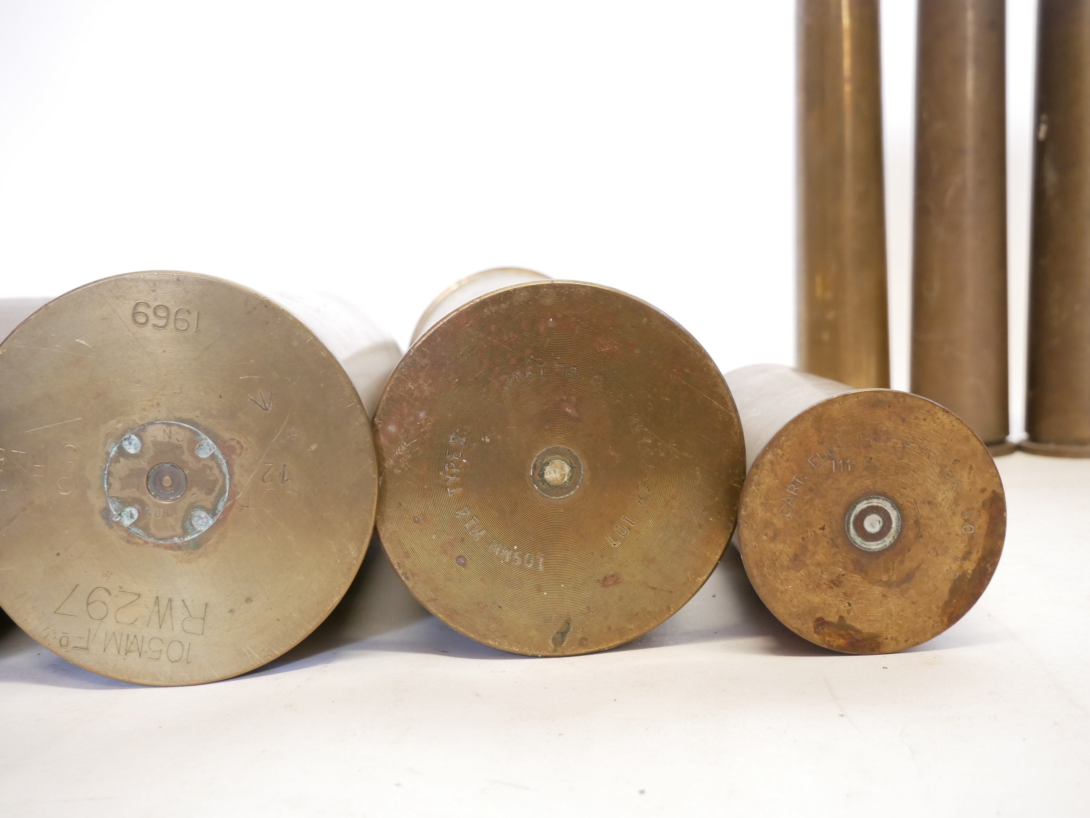 Lot 293 - Eight artillery shell cases and two dummy