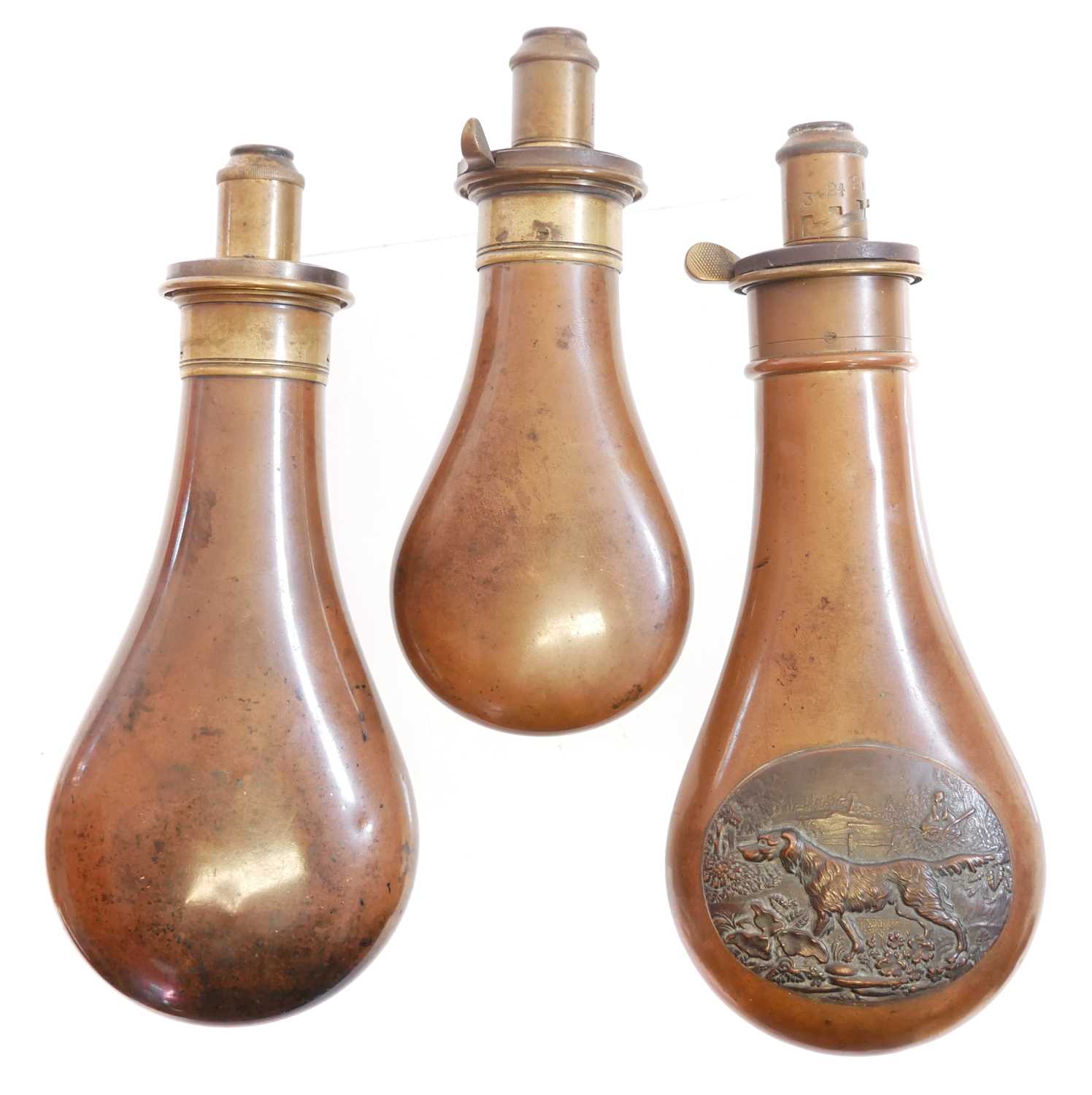 Lot 467 - Three copper and brass powder flasks by M.