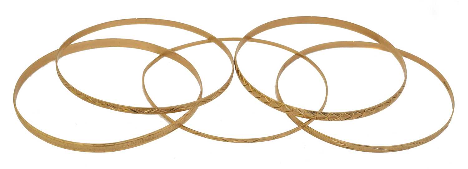 Lot 23 - Five 9ct gold bangles.