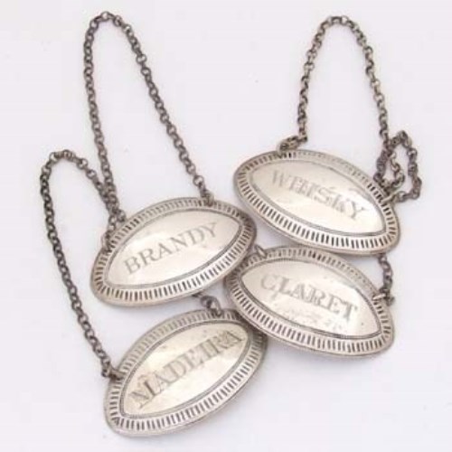 Lot 252 - Four silver wine labels.