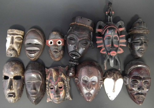 Lot 5 - Twelve African masks carved in various tribal